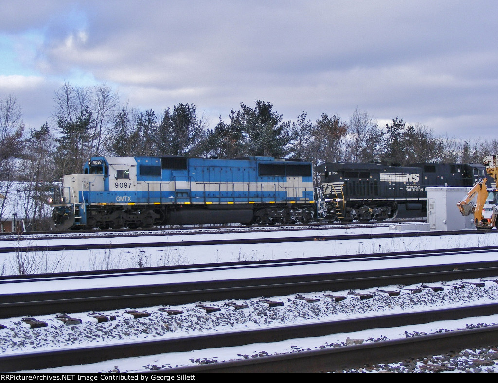 GMTX 9097 takes a group of autoracks west.